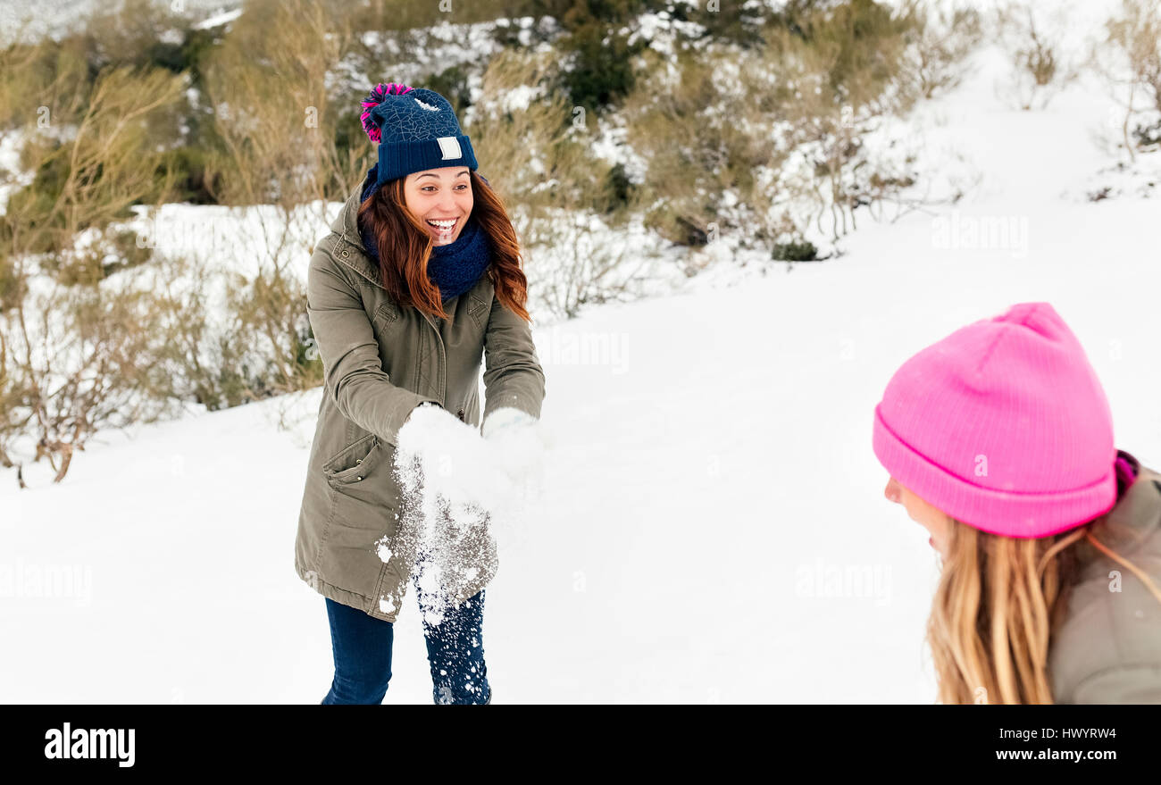 Two friends having fun in the snow Stock Photo - Alamy