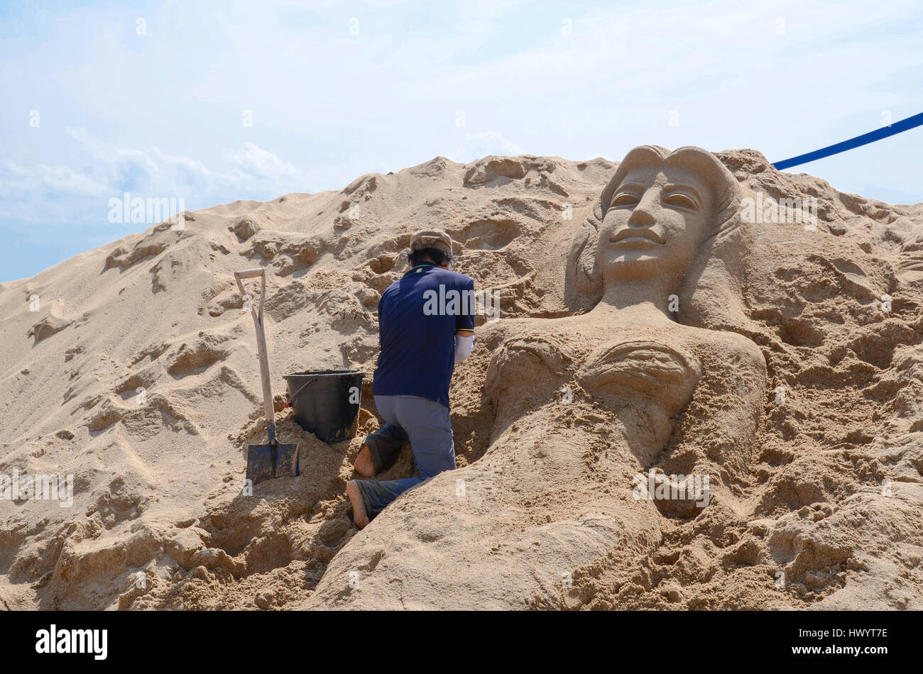 Sand artist making a sand sculpture Stock Photo - Alamy
