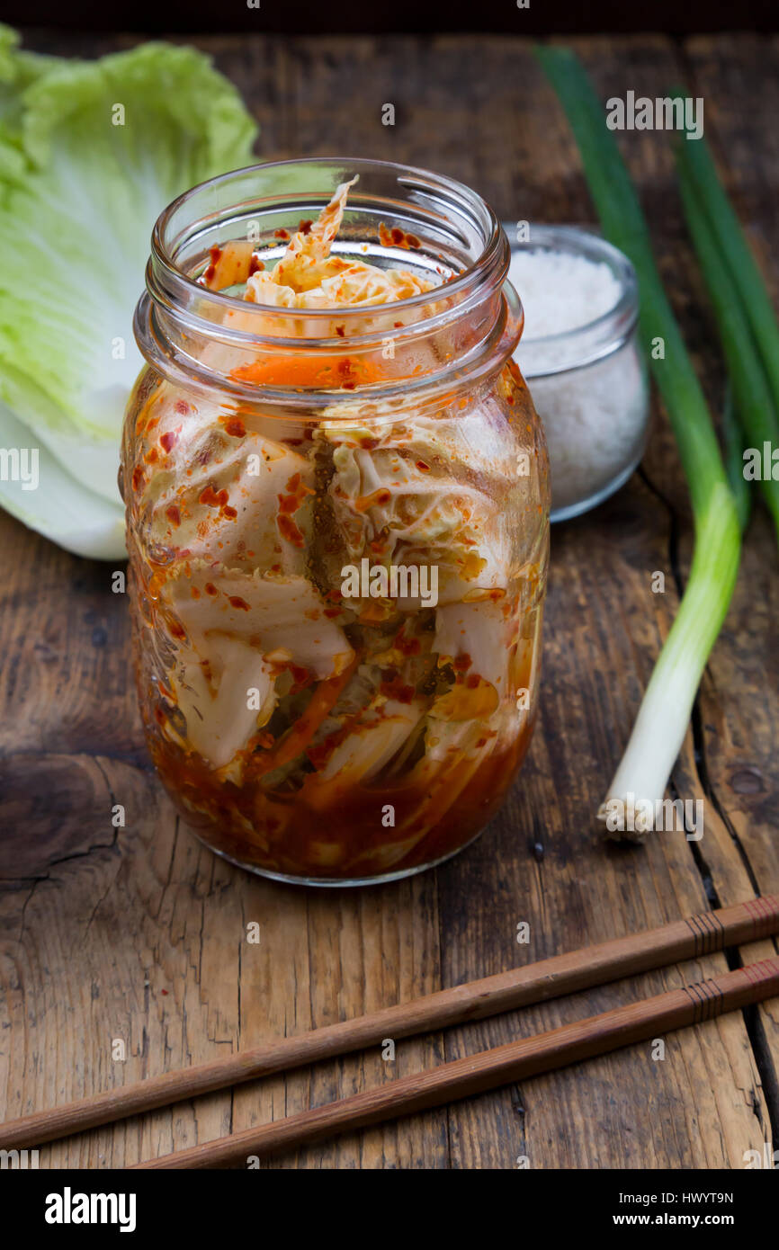 Glass of Kimchi, ingredients and chopsticks on dark wood Stock Photo ...