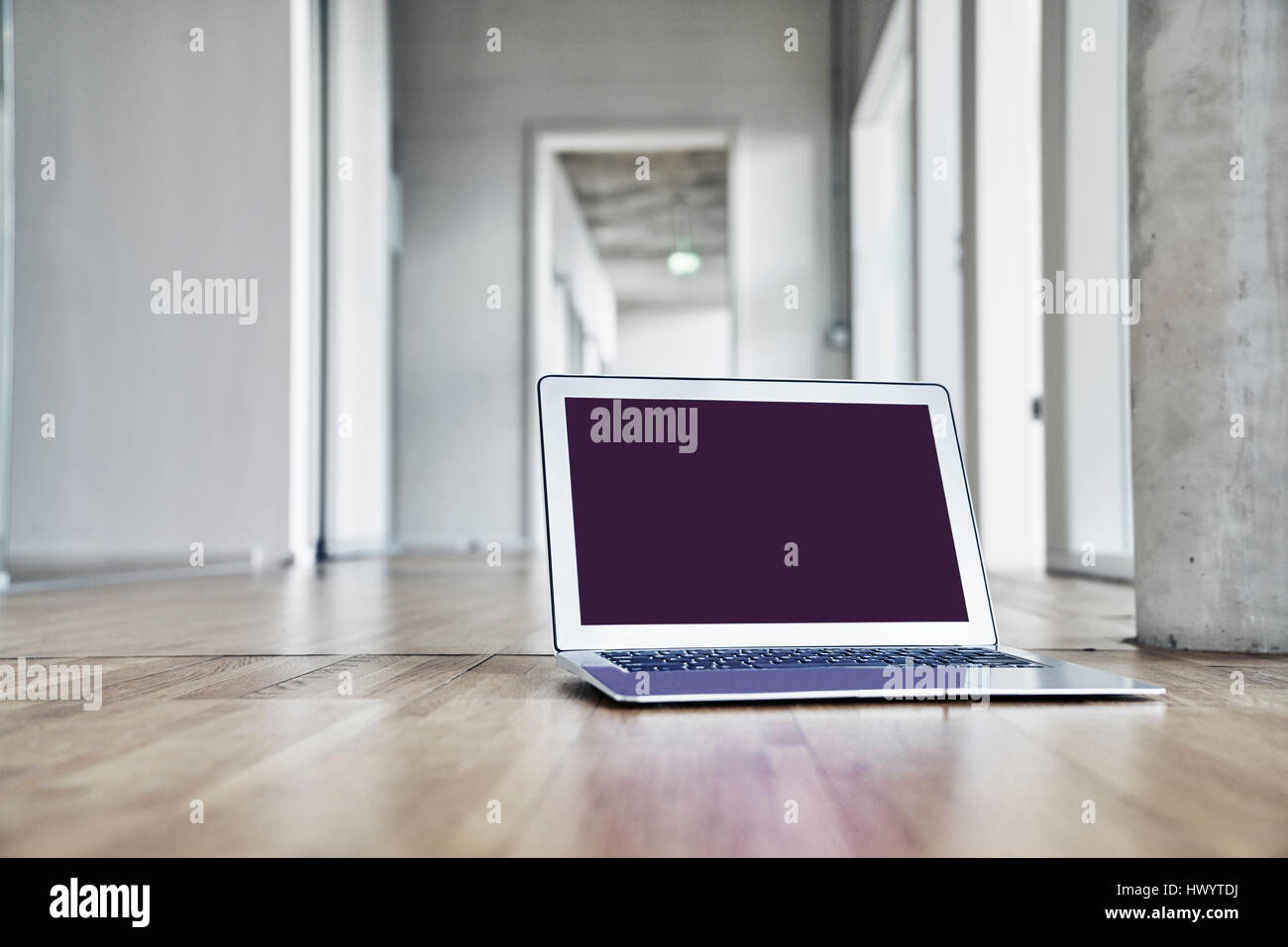Laptop in empty room Stock Photo - Alamy
