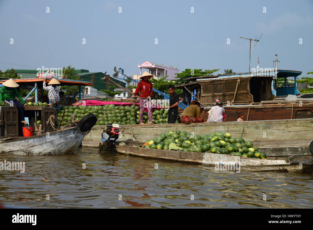 Melon sellers in the floating market loading melons on to their boat on ...
