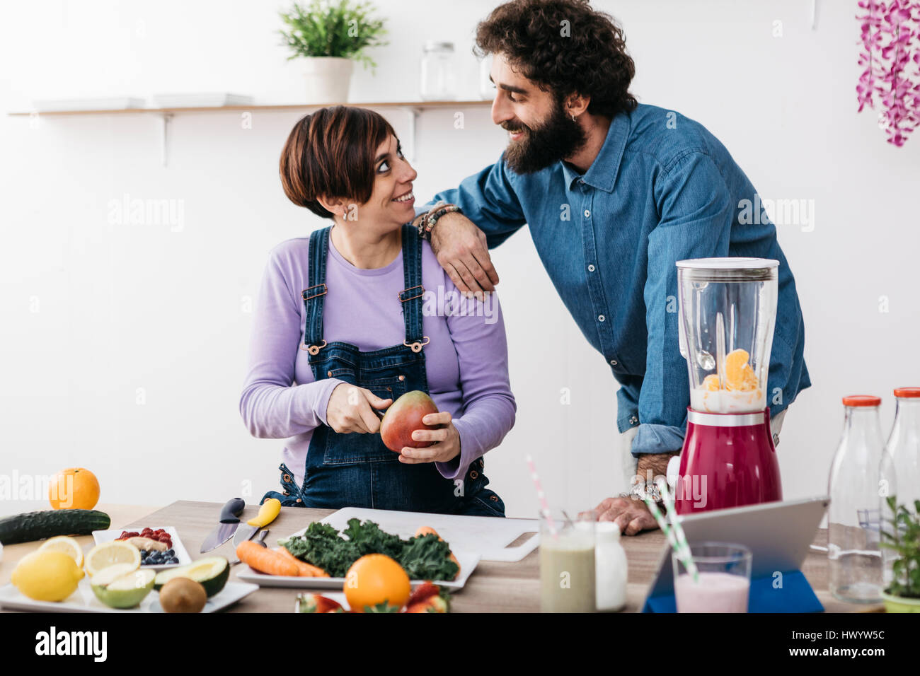 Couple in love in the kitchen Stock Photo - Alamy