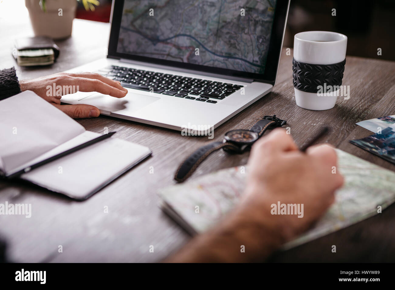 Man using laptop planning a trip Stock Photo - Alamy