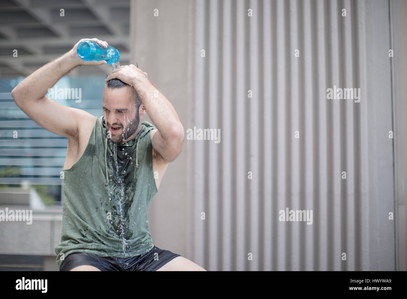 Man pouring water over head hi-res stock photography and images - Alamy