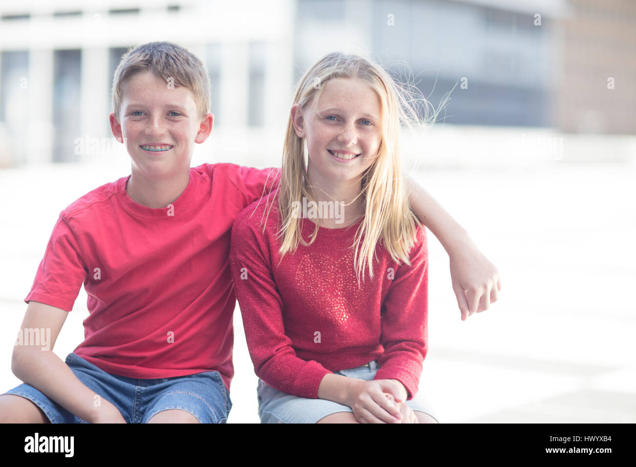Best friends sitting together in the street Stock Photo - Alamy