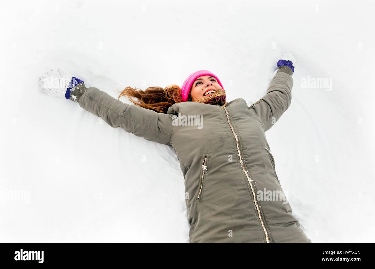 Young woman making a snow angel Stock Photo - Alamy