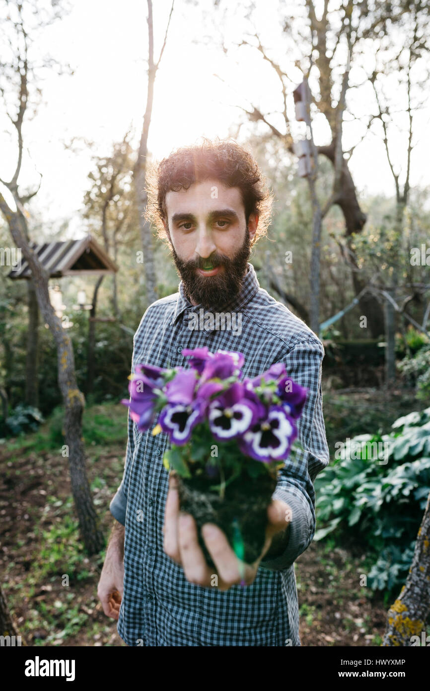 Man holding a flower in garden Stock Photo - Alamy