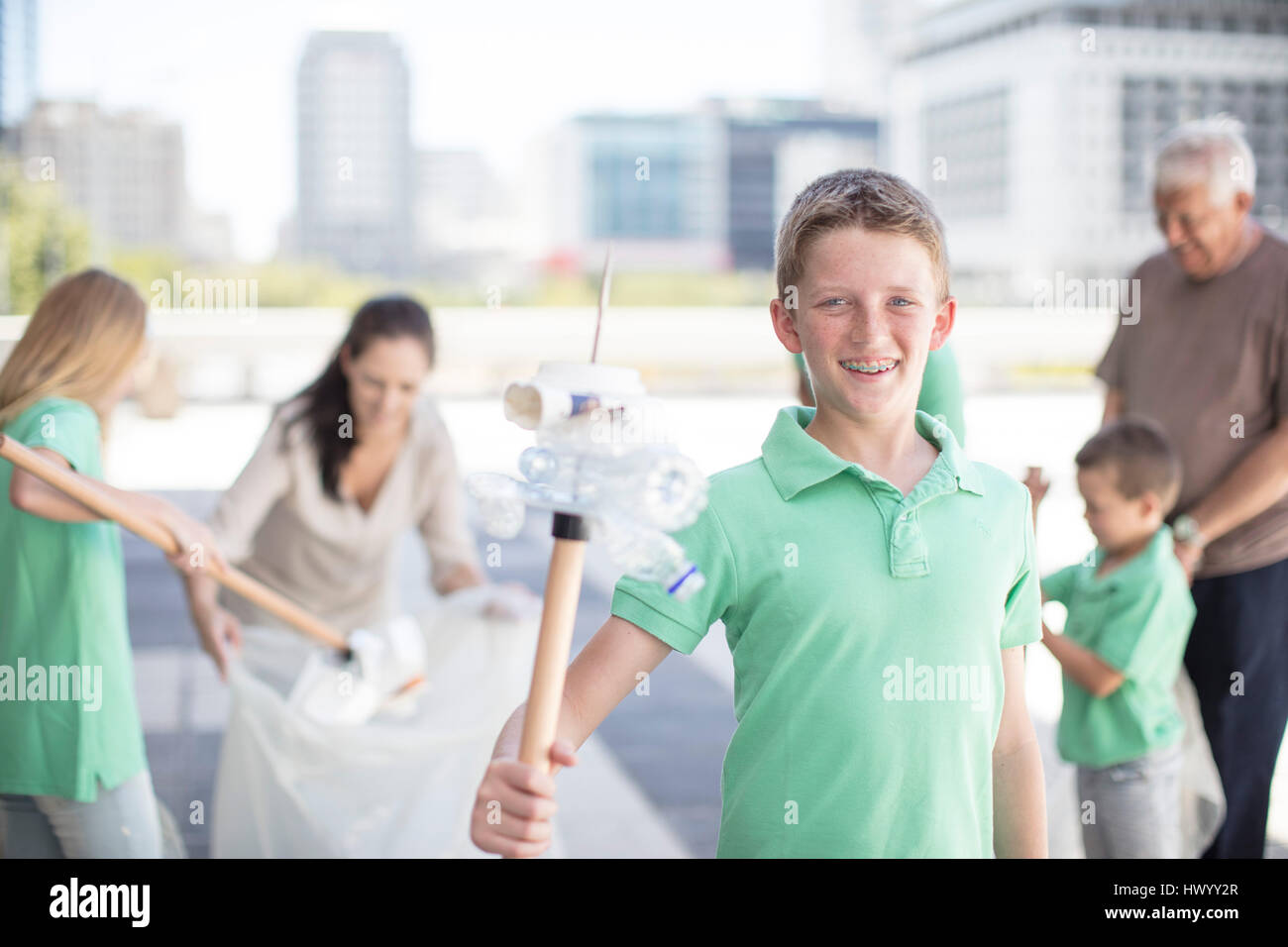 Group of volunteering children collecting garbage with litter sticks ...