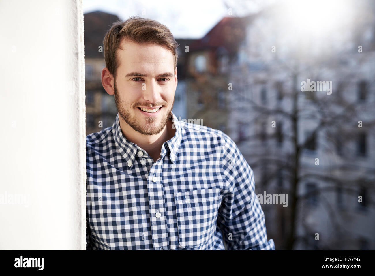 Portrait of smiling man in sunlight Stock Photo - Alamy
