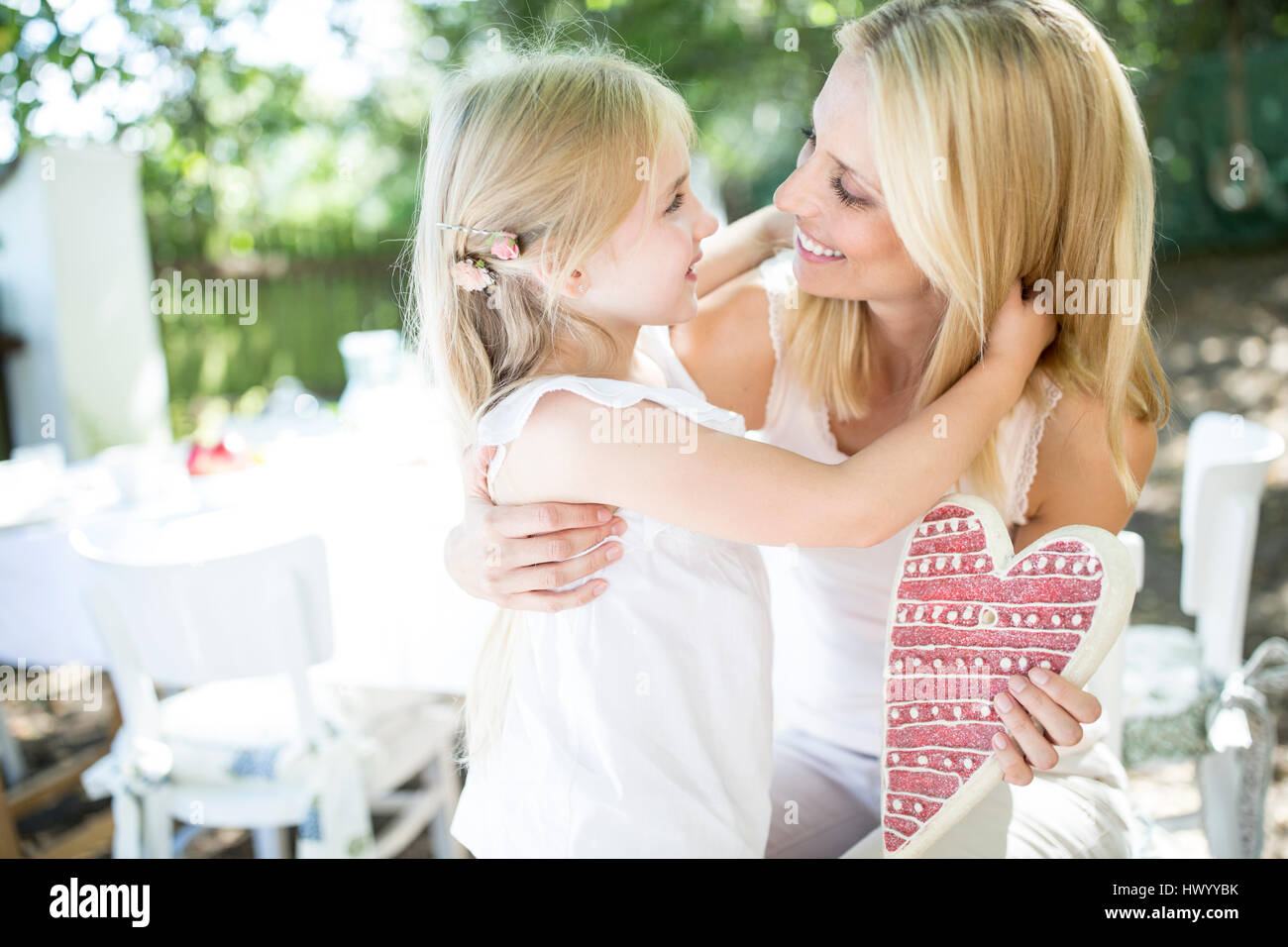 Happy mother receiving heart form her daughter Stock Photo - Alamy