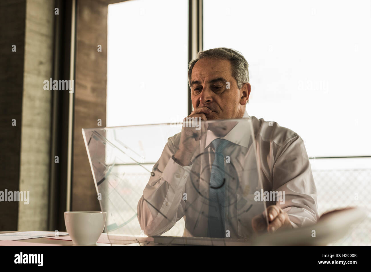 Senior manager in office using futuristic computer Stock Photo - Alamy