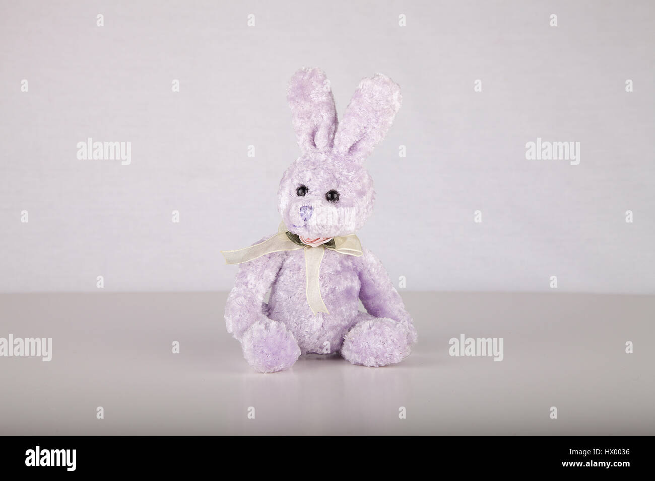 Purple Easter bunny on a white surface. Easter decoration isolated on ...