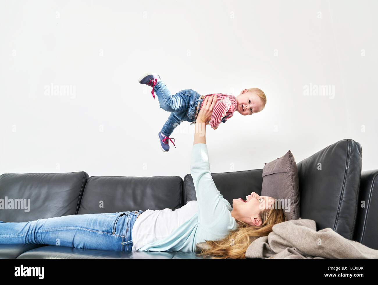 Parents lifting baby girl hi-res stock photography and images - Alamy