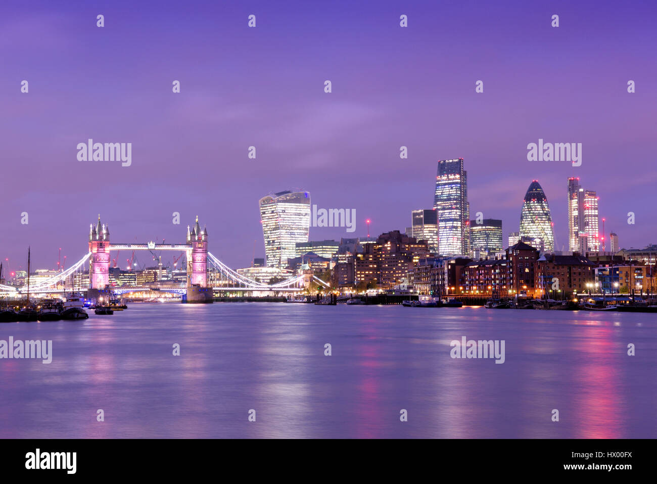 UK, London, skyline with River Thames and Tower Bridge at blue hour ...