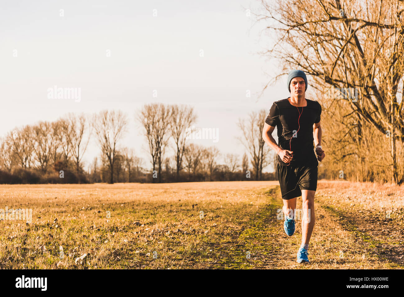 Man running in rural landscape Stock Photo - Alamy