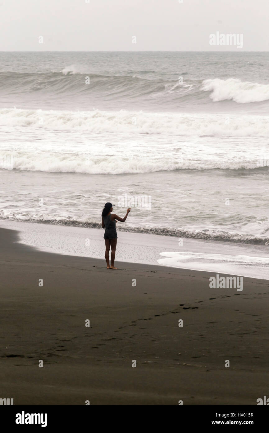 Indonesia, Java, woman at ocean coastline Stock Photo - Alamy