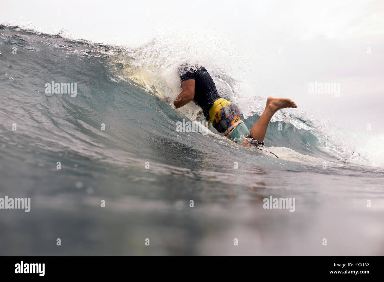 Indonesia, Java, water splashing over man surfing Stock Photo - Alamy
