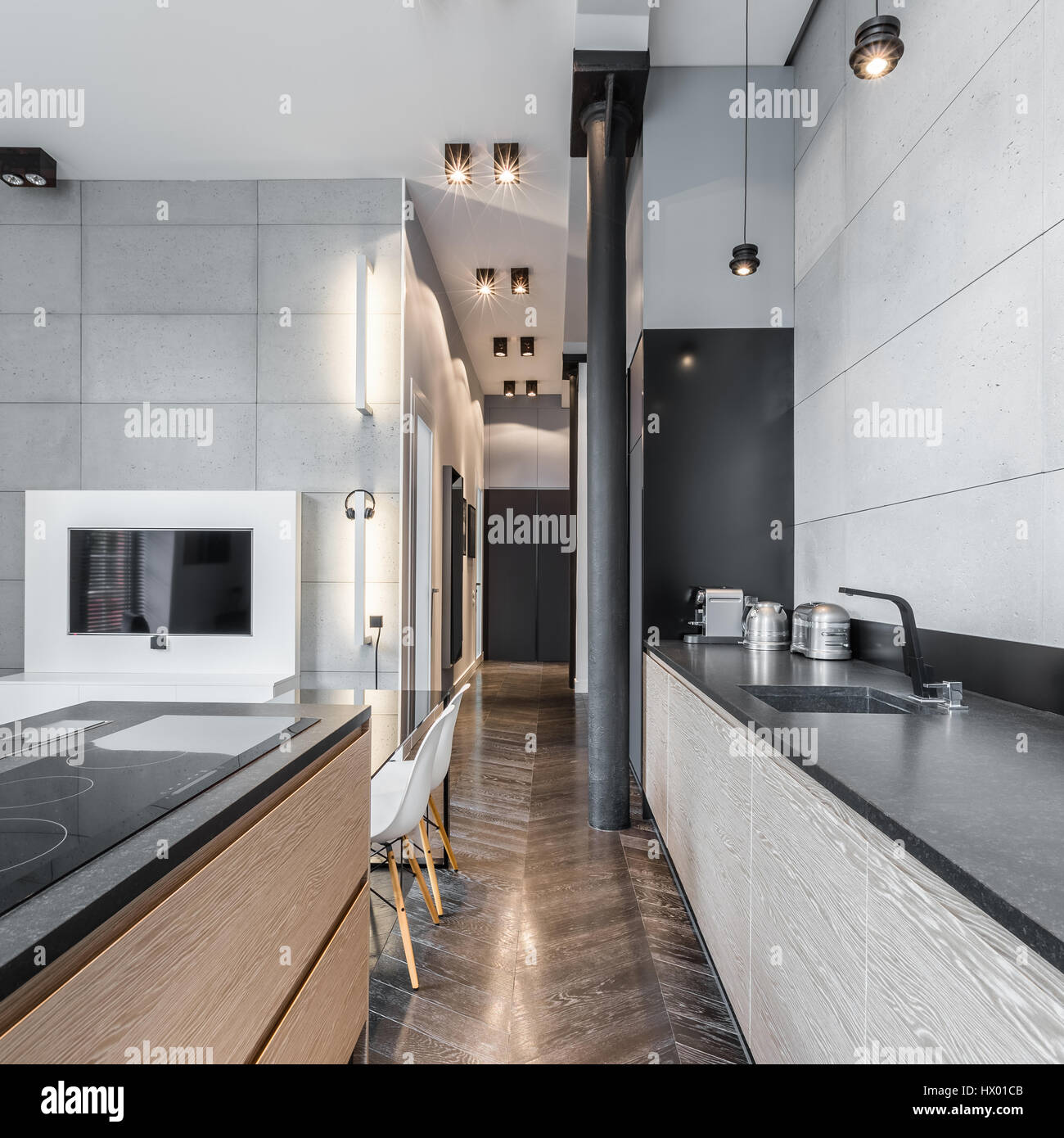 Functional kitchen with black long worktop and ceiling lights Stock ...