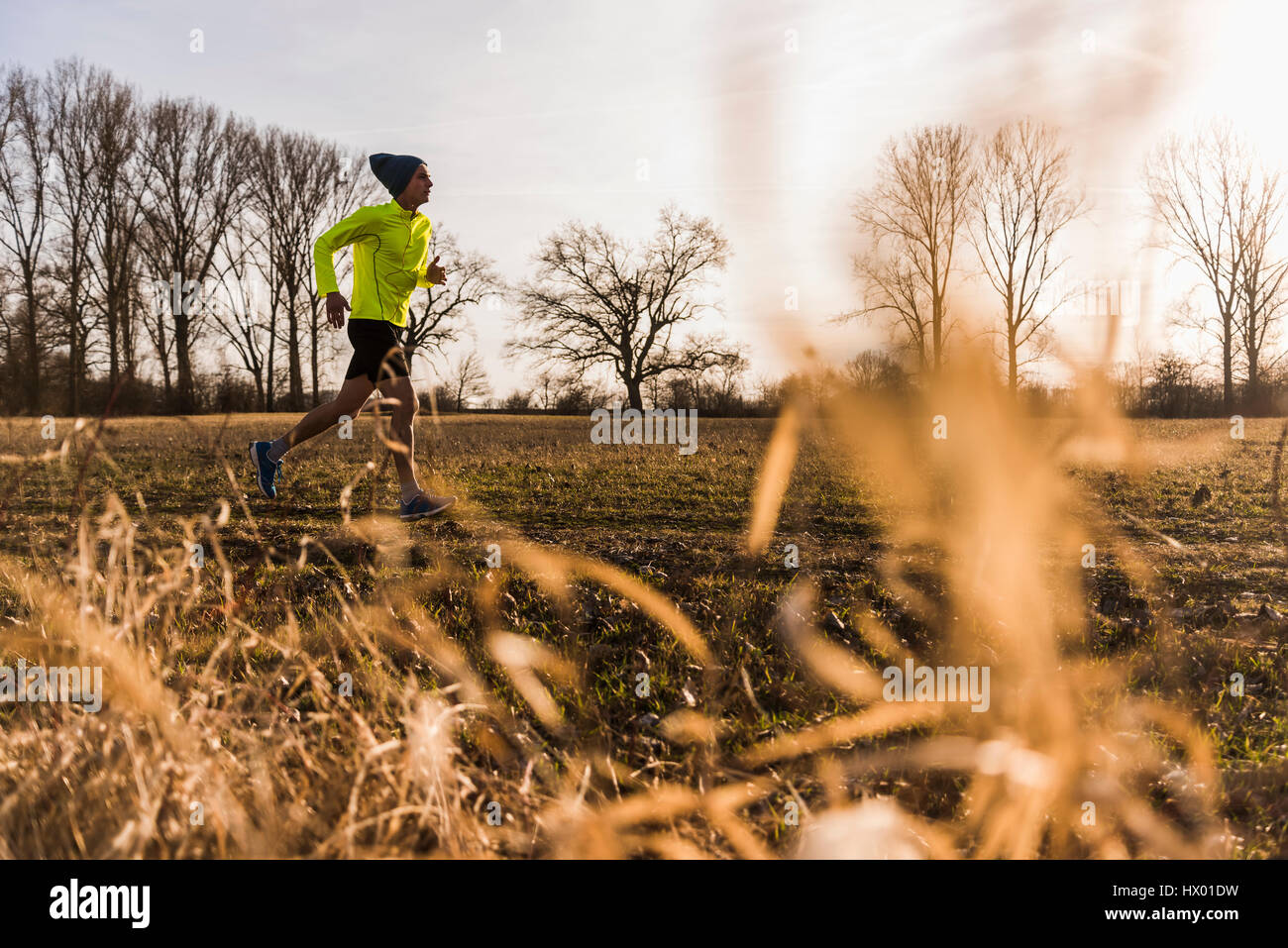 Man running in rural landscape Stock Photo - Alamy