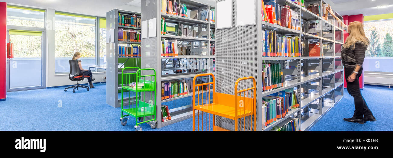 Panoramic view of light library interior with modern shelves and ...