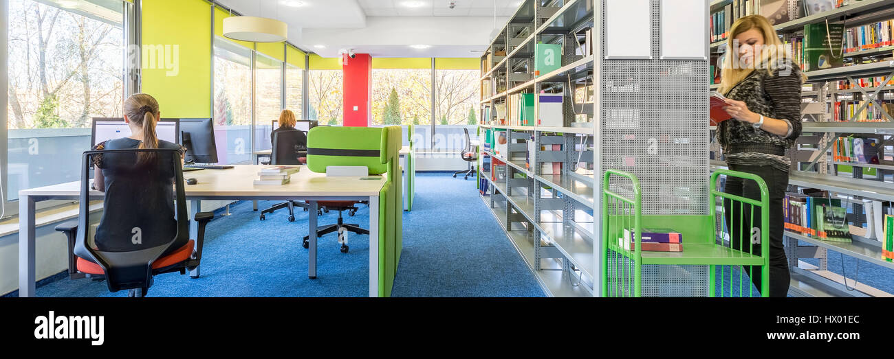 Panorama of colorful library interior with computer workstation and ...