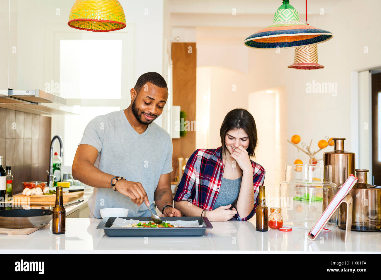 Young couple baking pizza at home Stock Photo - Alamy