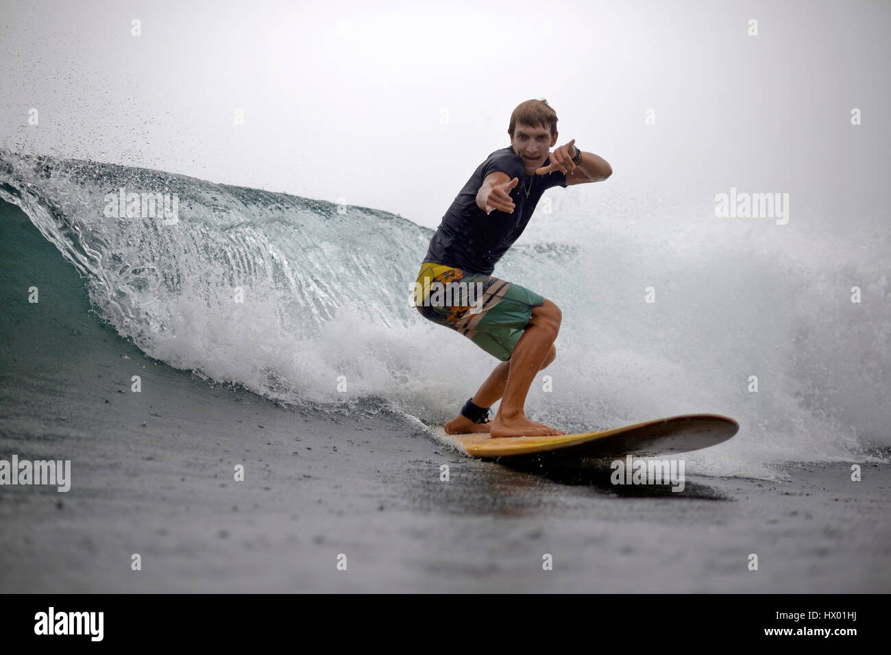 Indonesia, Java, man surfing and posing Stock Photo - Alamy
