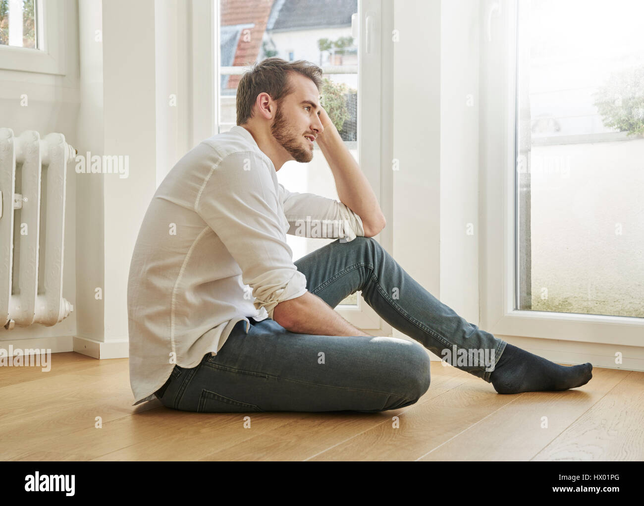 Man sitting on the floor Stock Photo - Alamy