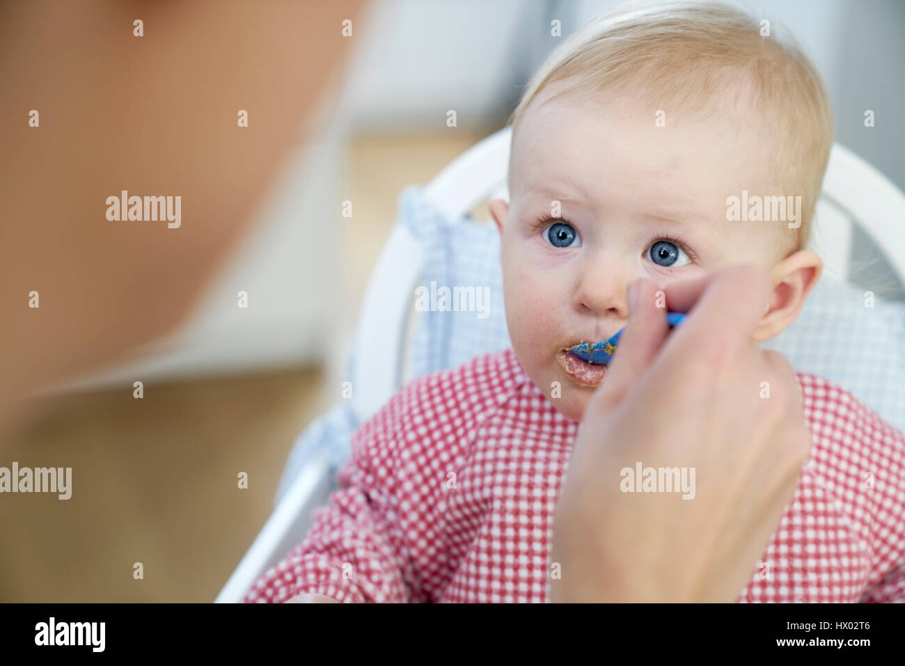 Baby girl being fed Stock Photo - Alamy