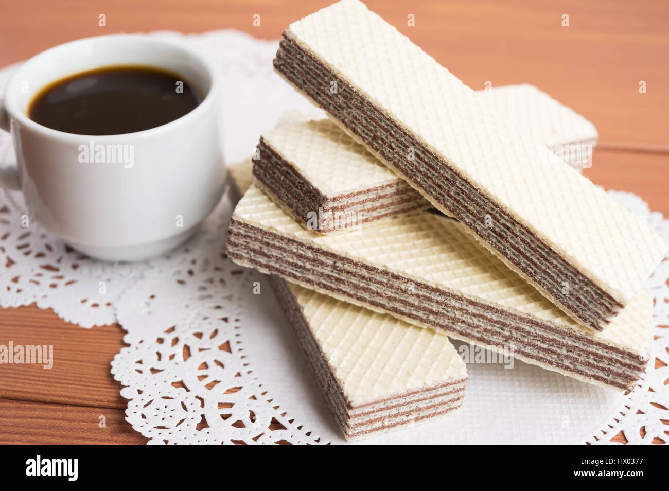 Crunchy chocolate wafers on white napkin and cup of coffee Stock Photo ...