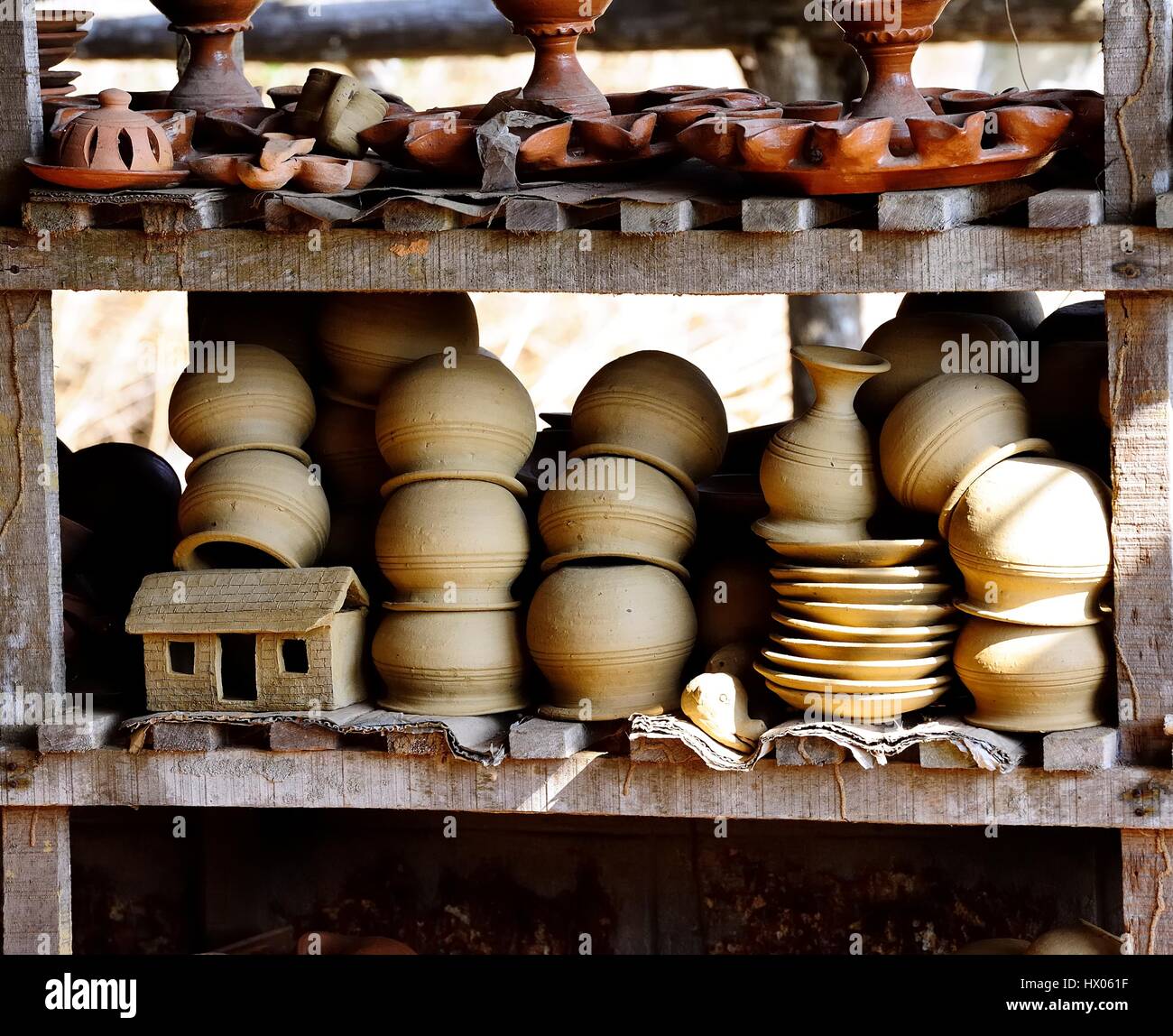 Handmade Pottery drying on the shelves Stock Photo - Alamy