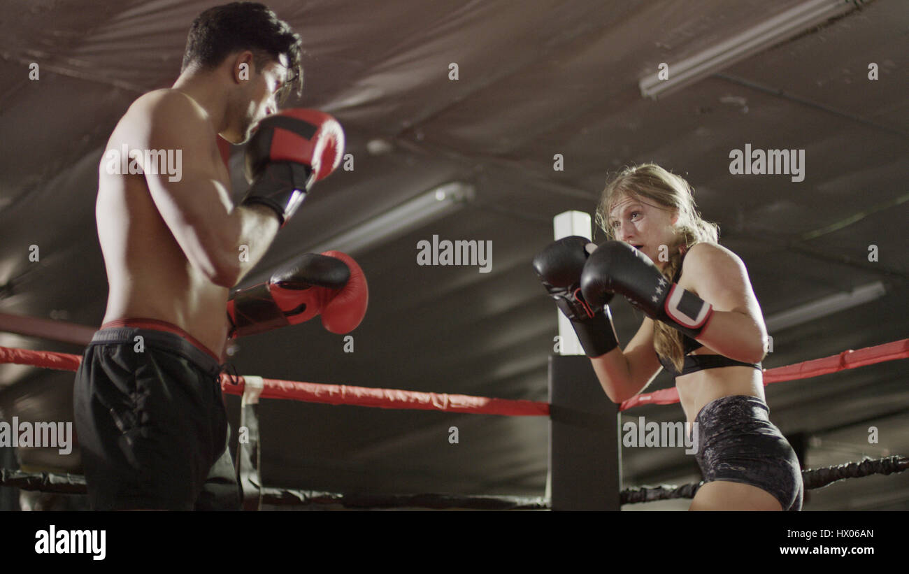 Low angle view of boxers punching and fighting in boxing ring during ...
