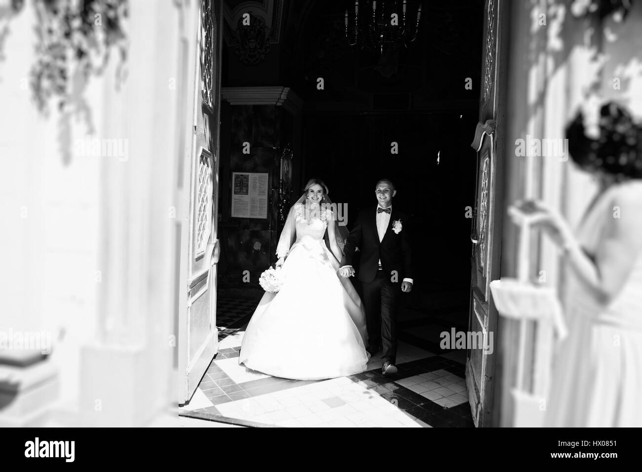 Wedding couple exit from church after wedding ceremony Stock Photo - Alamy
