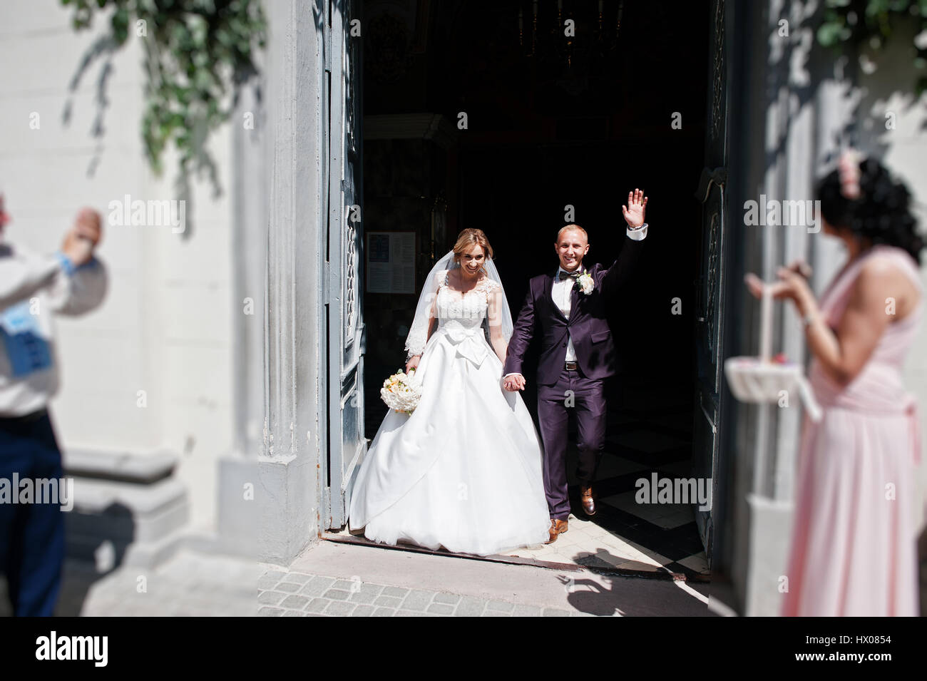 Wedding couple exit from church after wedding ceremony Stock Photo - Alamy