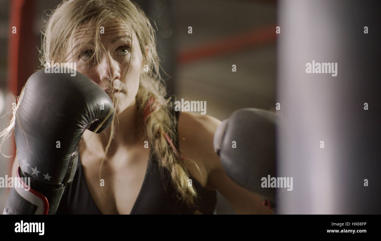 Low angle view of female boxer protecting her face standing in boxing ...