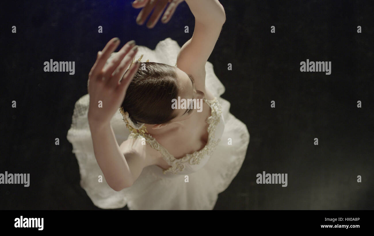 Overhead view of serious ballet dancer dancing in costume Stock Photo ...