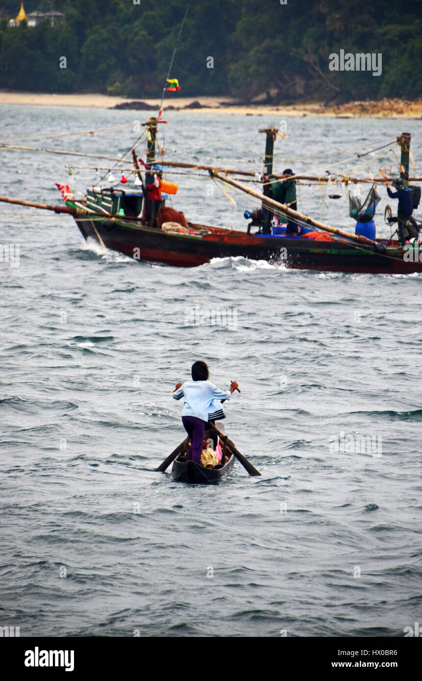 A young girl rows a traditional boat to the village of Makyone Galet ...