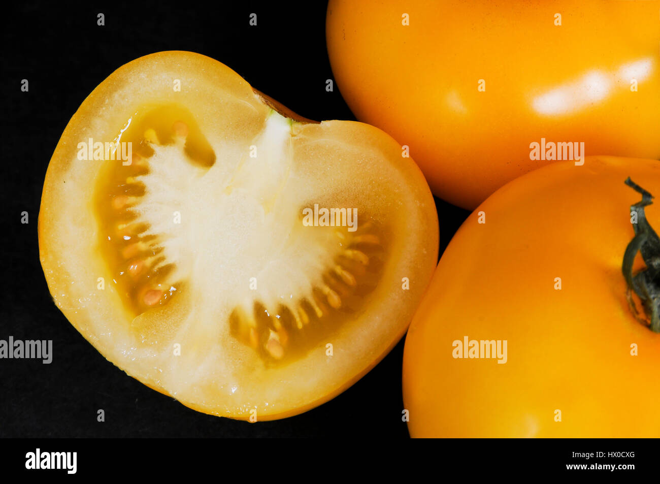 Yellow Tomatoes - Whole and Sliced Stock Photo - Alamy