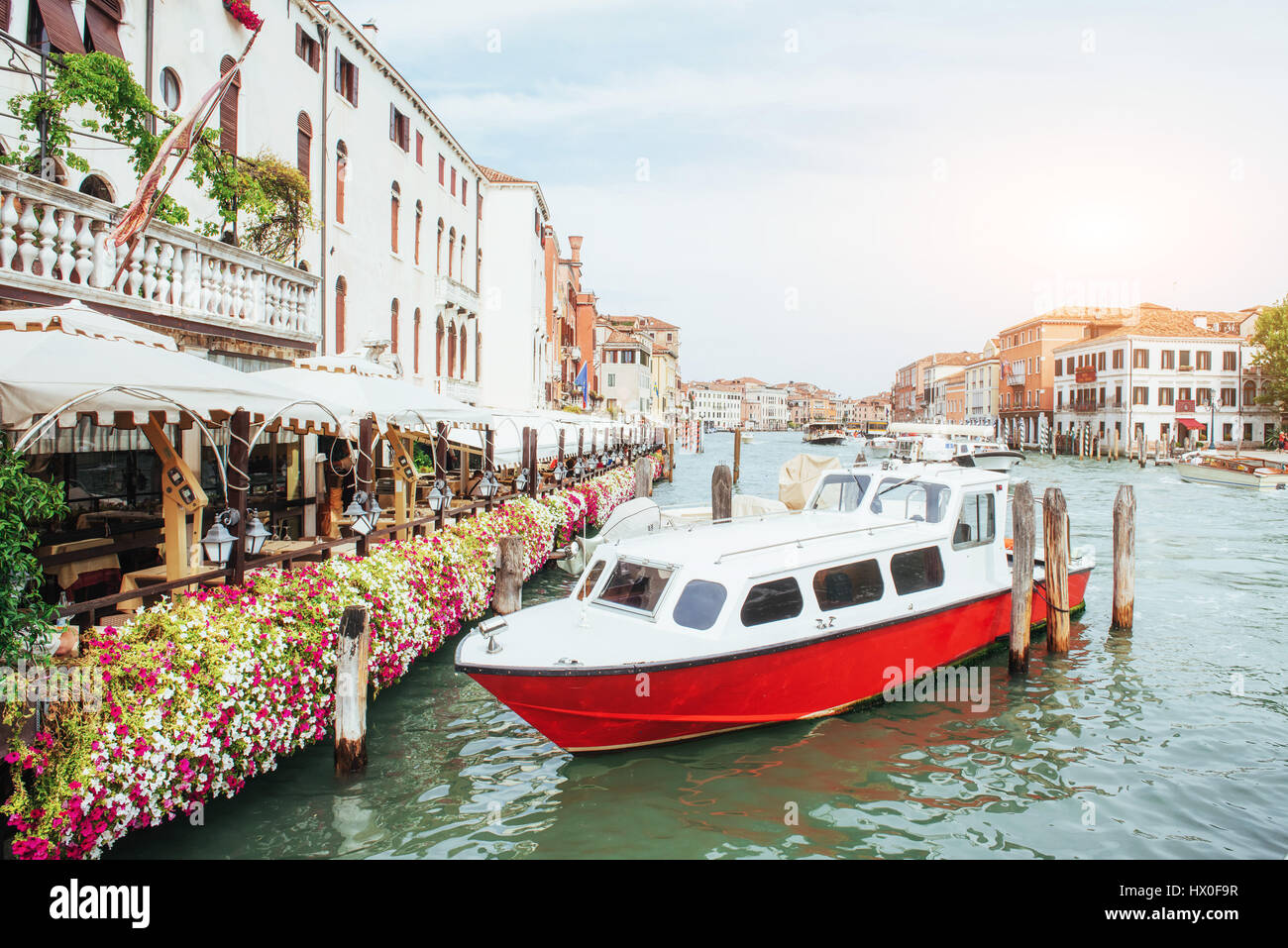 Green water channel with gondolas and colorful facades of old medieval ...