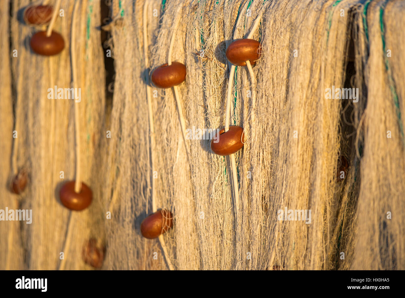 Fishing net and its orange floating devices Stock Photo - Alamy