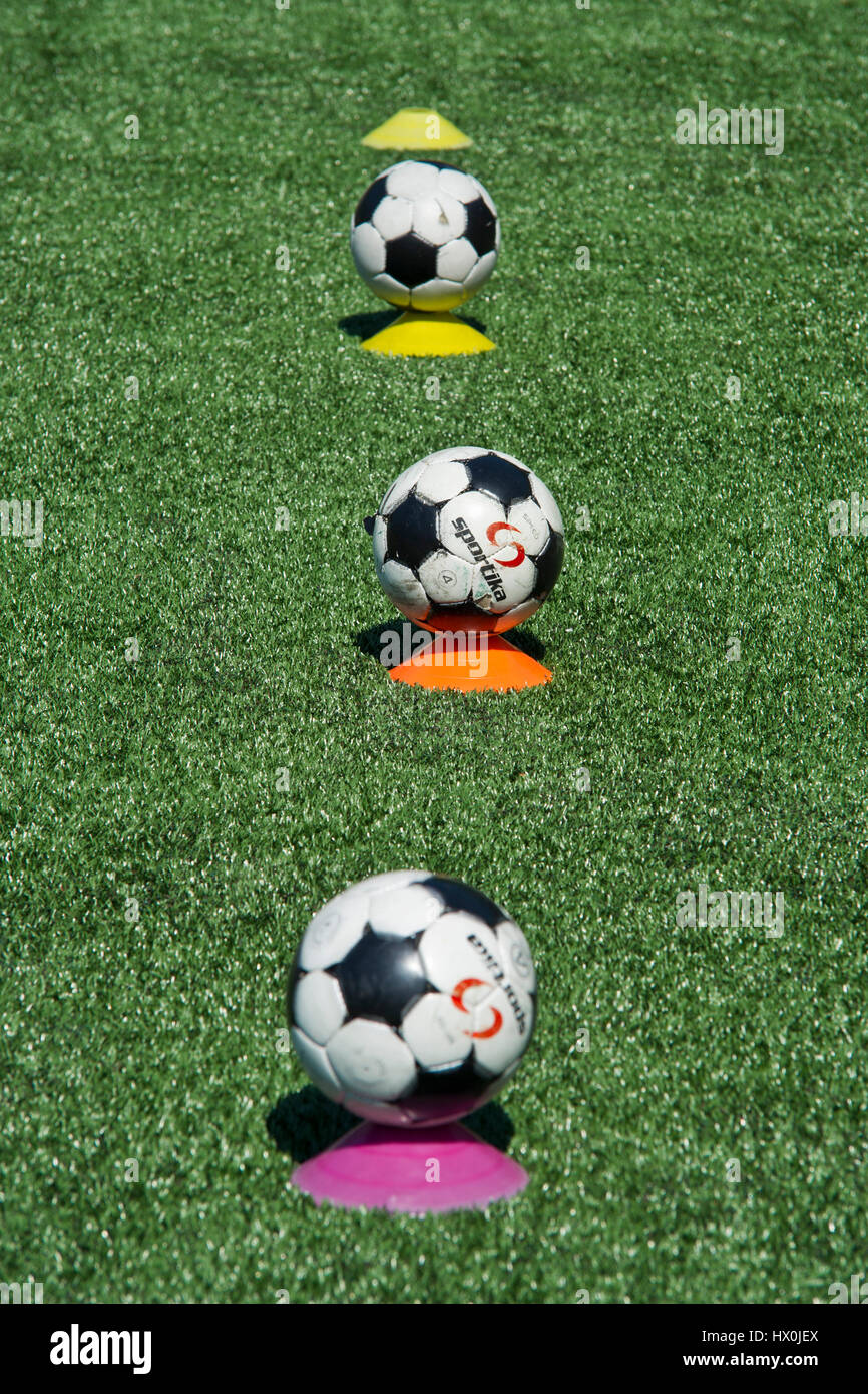 Three soccer balls on a meadow Stock Photo - Alamy