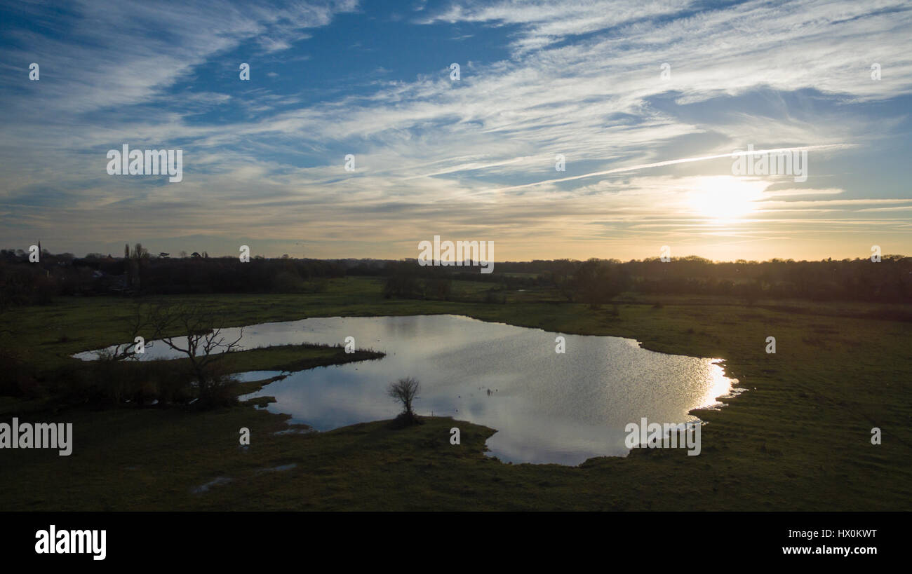 Aerial view over a lake in the winter, with reflections, UK Stock Photo ...