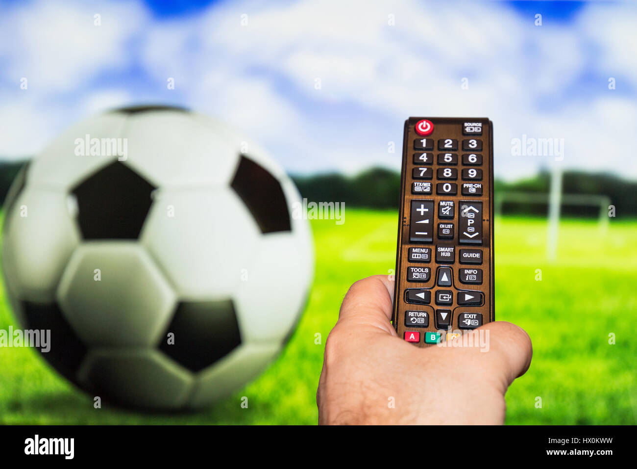 Watching soccer / football game on modern tv, with a close-up of the ...