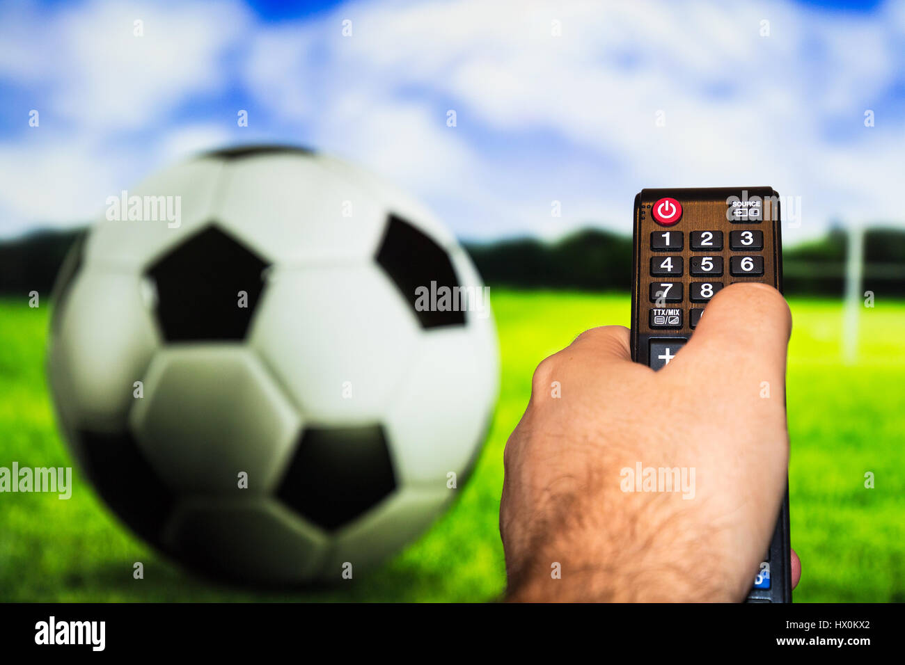 Watching soccer / football game on modern tv, with a close-up of the ...
