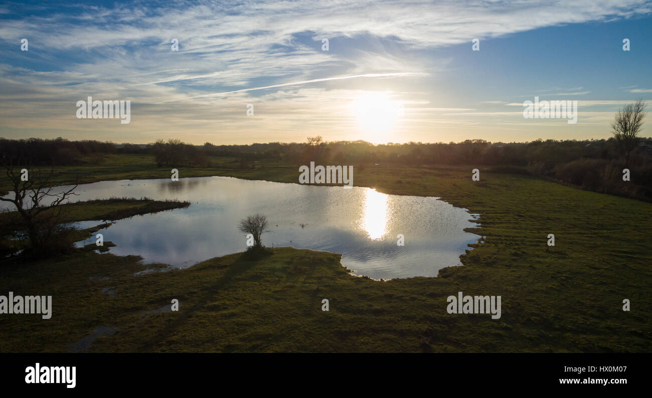 Aerial view over a lake in the winter, with reflections, UK Stock Photo ...