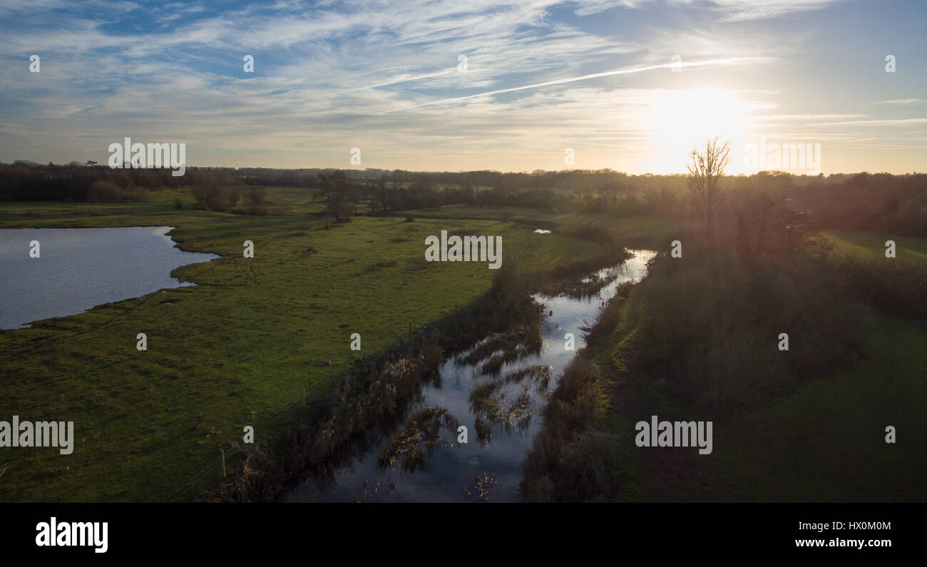 Aerial view over a lake in the winter, with reflections, UK Stock Photo ...