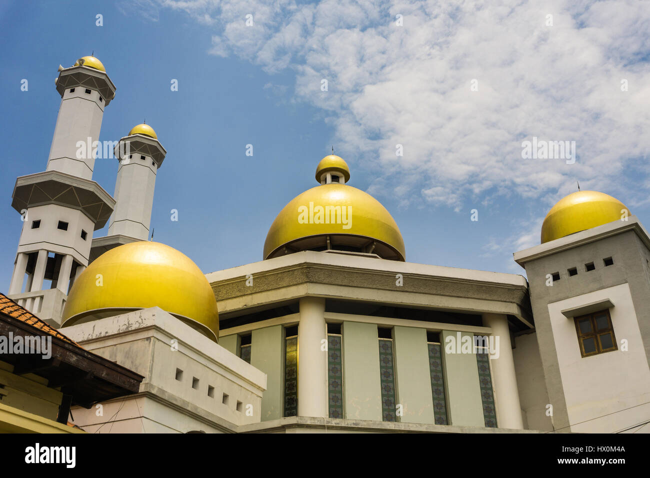 the gold dome of a mosque with cloudy sky as background photo taken ...