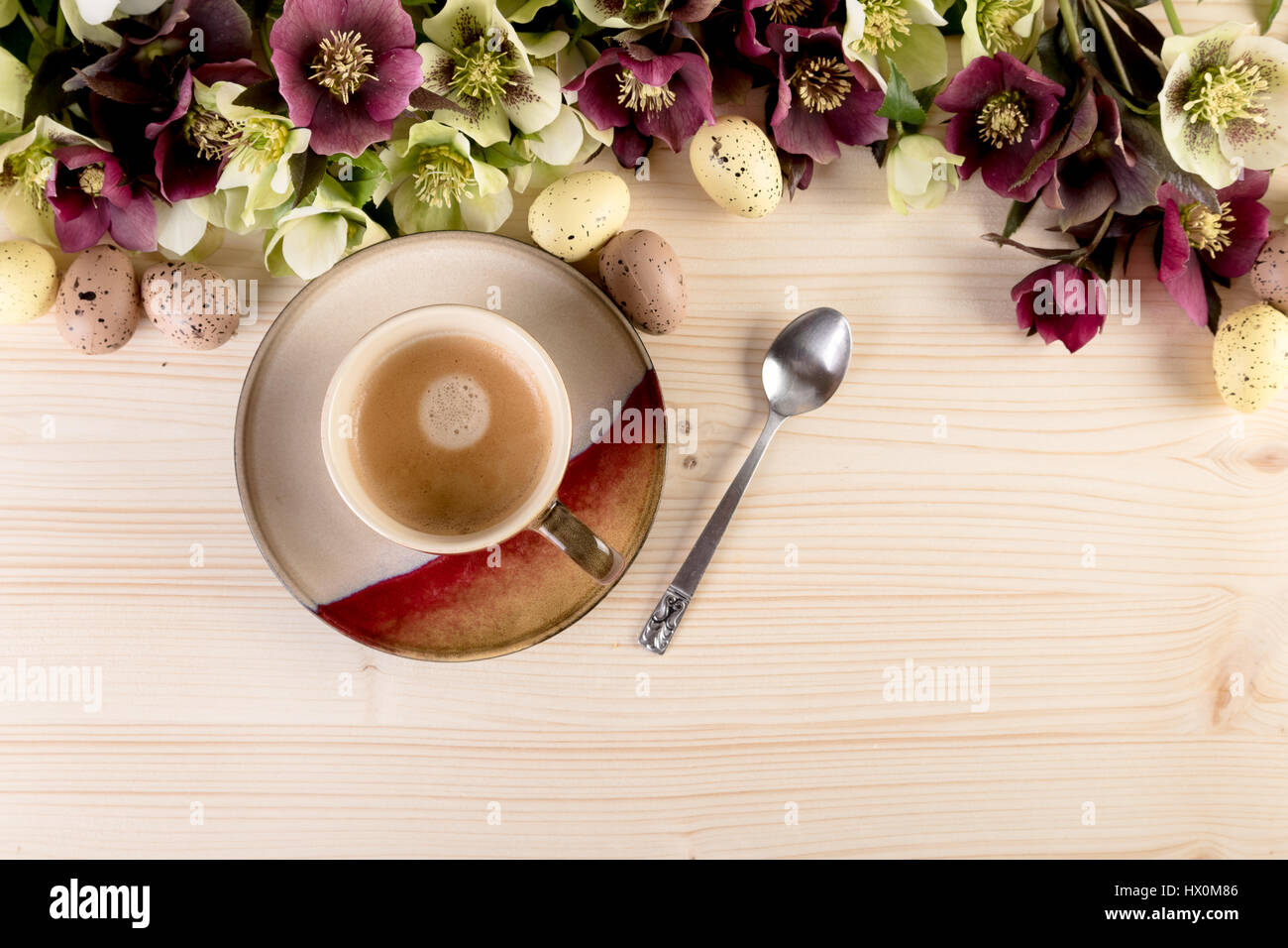 Coffee concept Easter eggs with spring flowers over wood. Top view ...