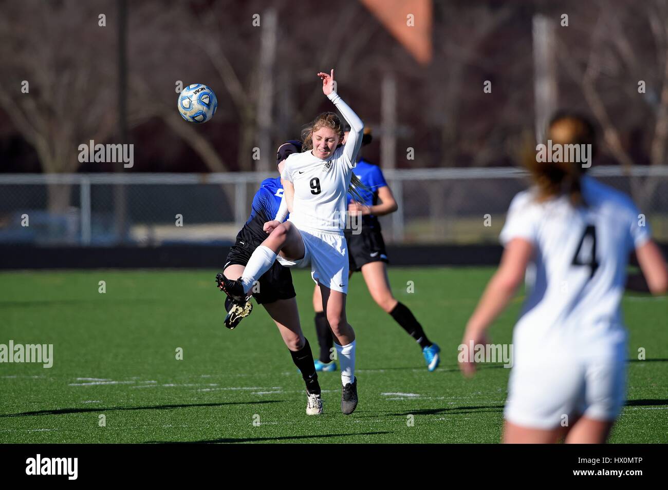 Defender using a kick to clear the ball from deep in her end of the ...