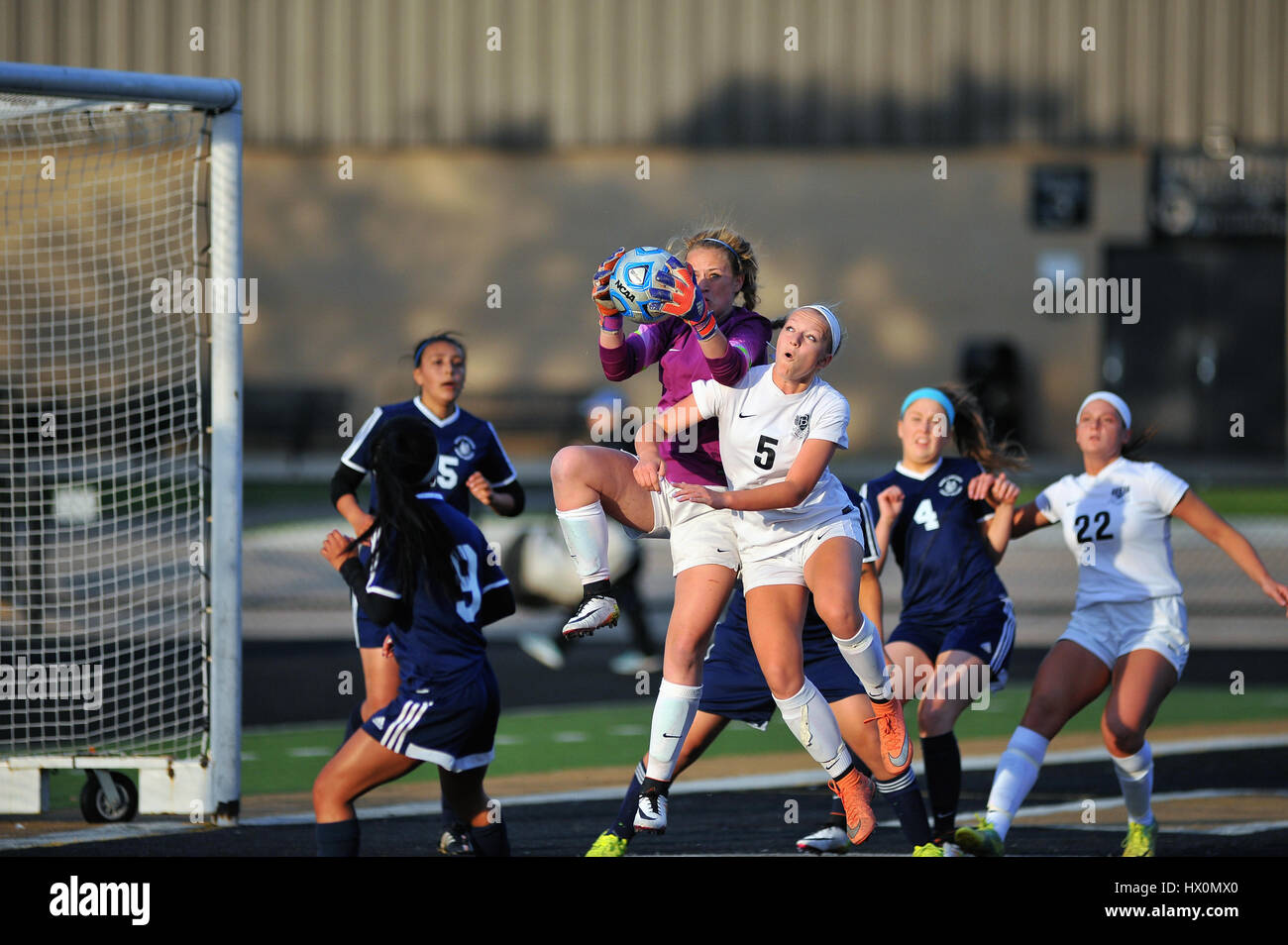 Keeper making a save off a corner kick while depriving an opponent of a ...